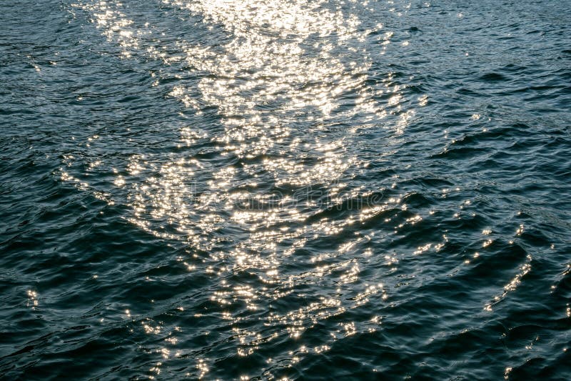 Sunset Reflections, Rippling Water Surface with Golden and Blue Hues at ...