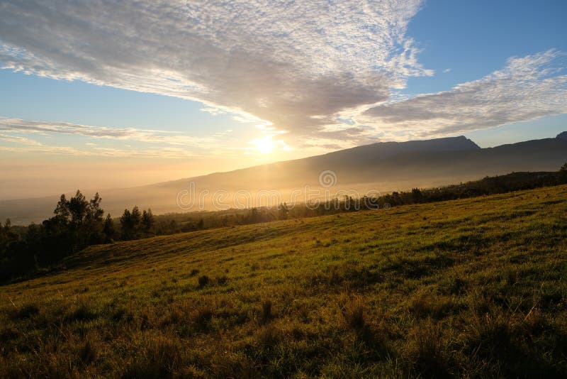 Sunset on the Reunion Island Stock Photo - Image of field, clouds ...
