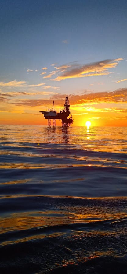 Sunset at rig offshore stock photo. Image of sunset - 263881468