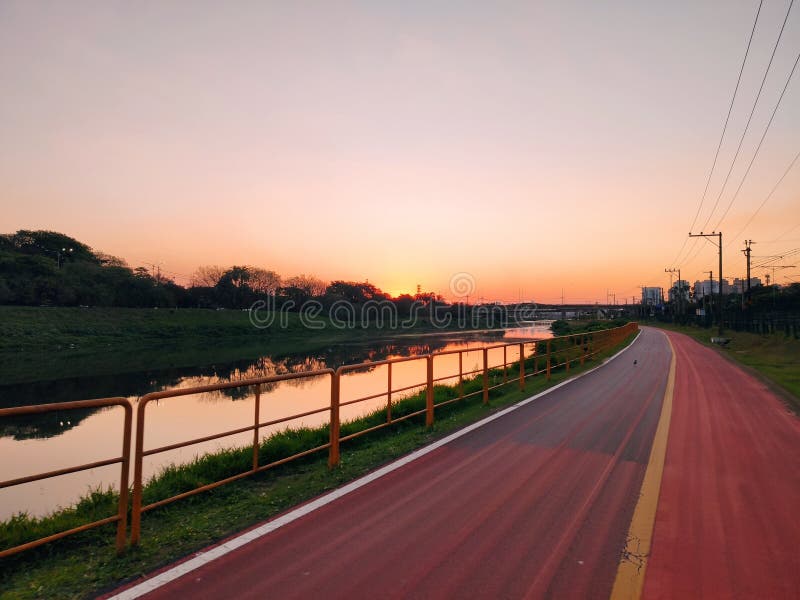 Sunset on a bike path stock photo. Image of reflection - 200621138