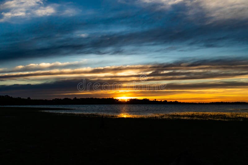 Sunset river horizon view stock image. Image of summer - 135785663