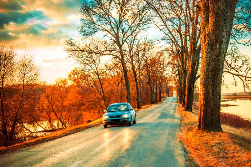Sunset road and car stock image. Image of light, countryside - 69492463