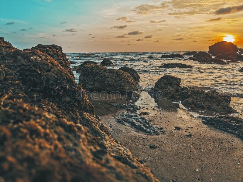 Sunset rock beach bungai stock photo. Image of water - 205773408