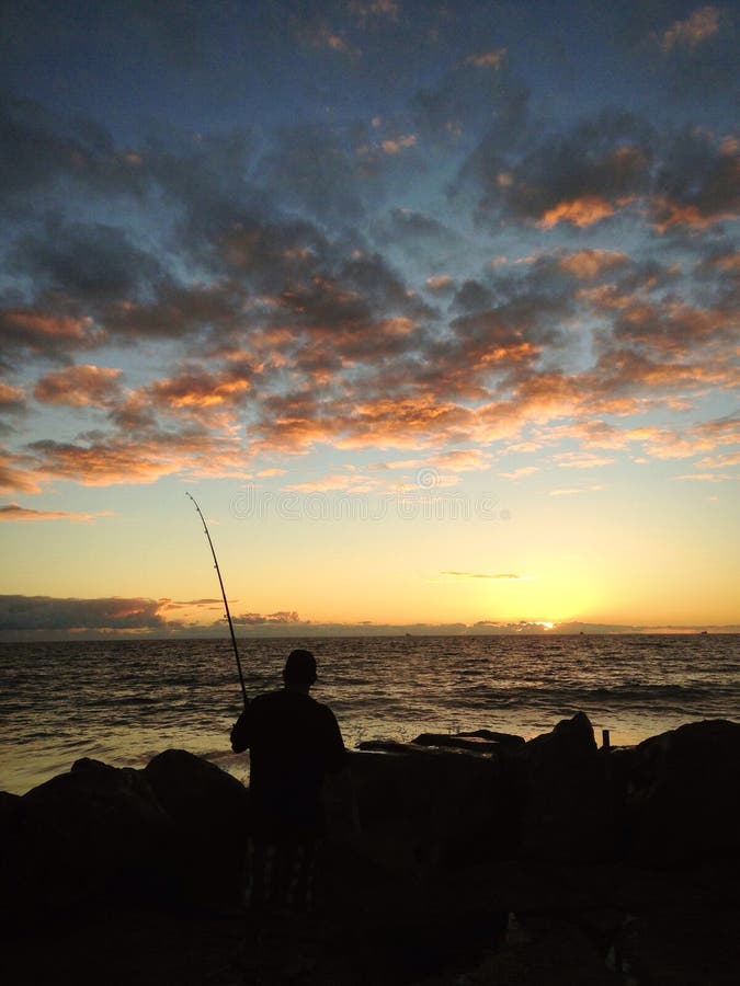 Sunset rock fishing editorial stock photo. Image of life - 44044538
