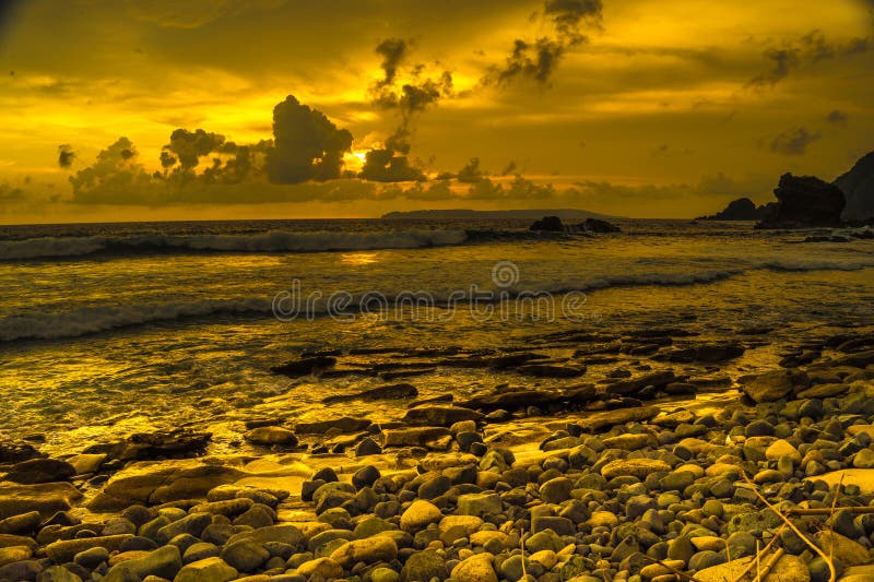 Sunset at the Rocky Beach in Papuma, Jember, East Java, Indonesia Stock ...