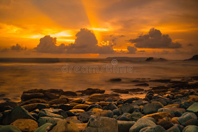 Sunset at the Rocky Beach in Papuma, Jember, East Java, Indonesia Stock ...