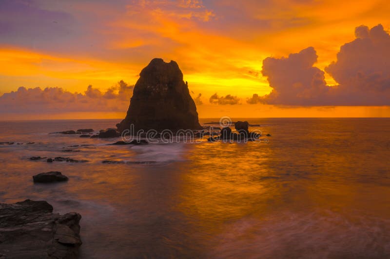 Sunset at the Rocky Beach in Papuma, Jember, East Java, Indonesia Stock ...
