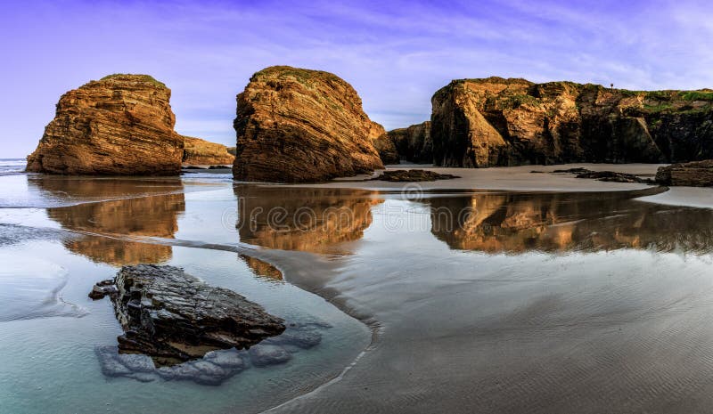 Sunset on a Sandy Beach with Tidal Pools and Jagged Broken Cliffs ...