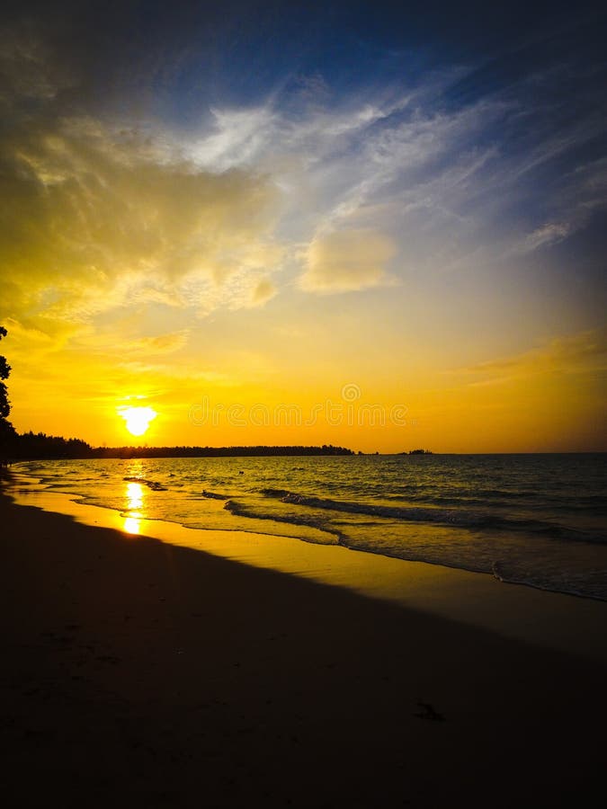 Sunset on the sandy beach stock photo. Image of sunny - 107442238