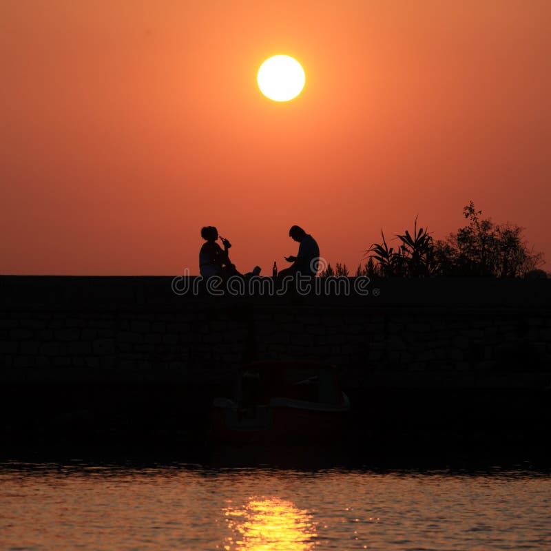 Sunset Scene with People Silhouettes, Sea and Sun Road Stock Photo ...