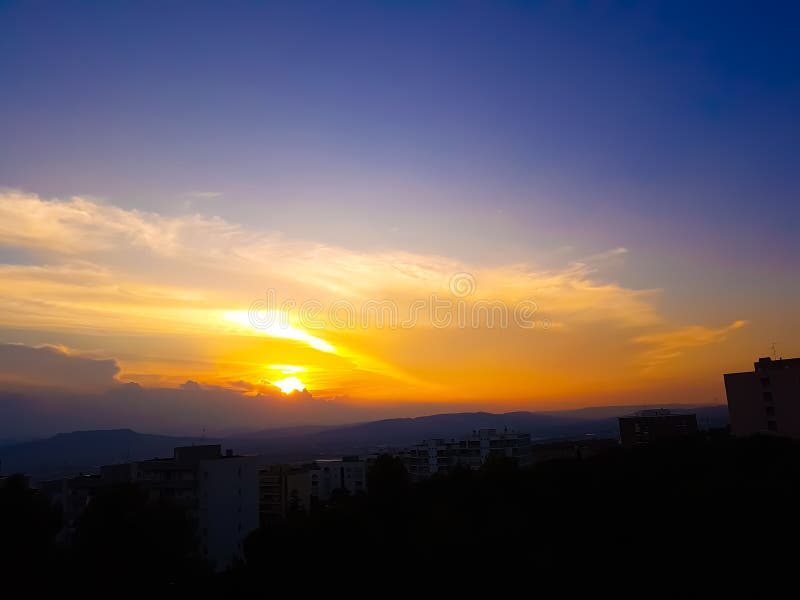 Sunset Scene with Sun Fall Behind the Clouds and Mountains in ...