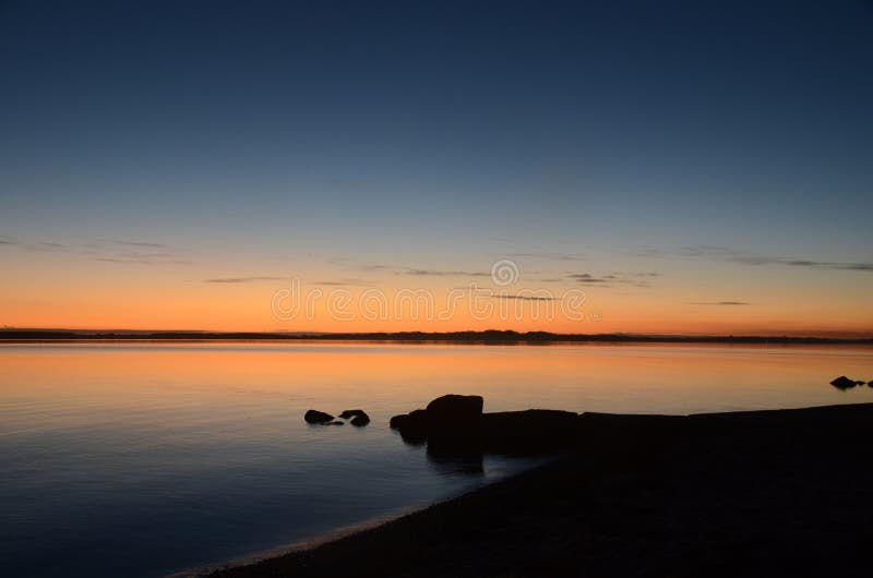 After sunset at sea stock photo. Image of calm, mirror - 203552250