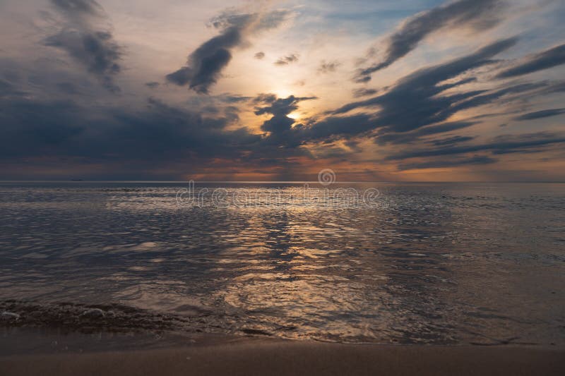 Sunset In The Sea With Clouds And Calm Water Stock Image - Image of ...