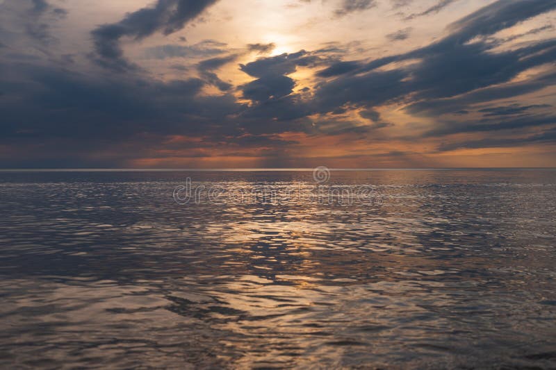 Sunset In The Sea With Clouds And Calm Water Stock Image - Image of ...