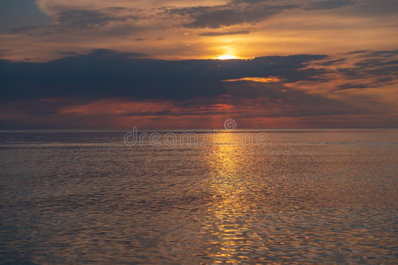 Sunset In The Sea With Clouds And Calm Water Stock Image - Image of ...