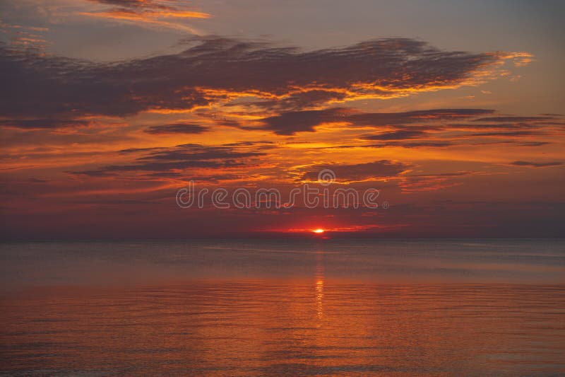Sunset In The Sea With Clouds And Calm Water Stock Image - Image of ...