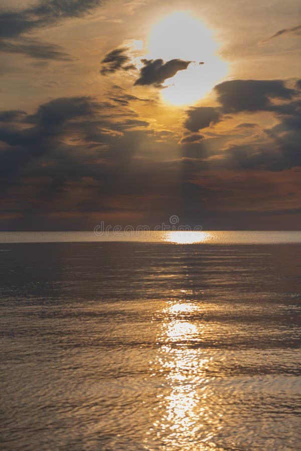 Sunset in the Sea with Clouds and Calm Water Stock Photo - Image of ...