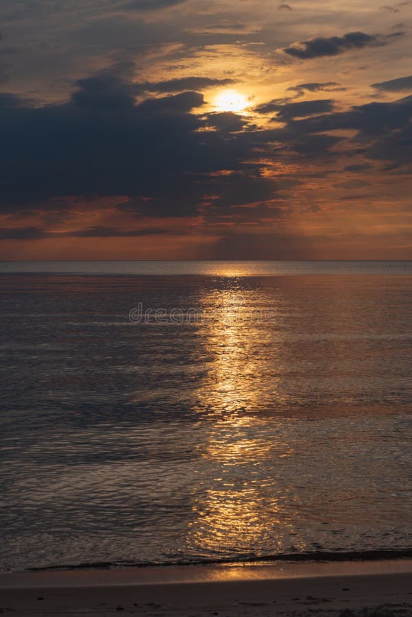Sunset in the Sea with Clouds and Calm Water Stock Image - Image of ...