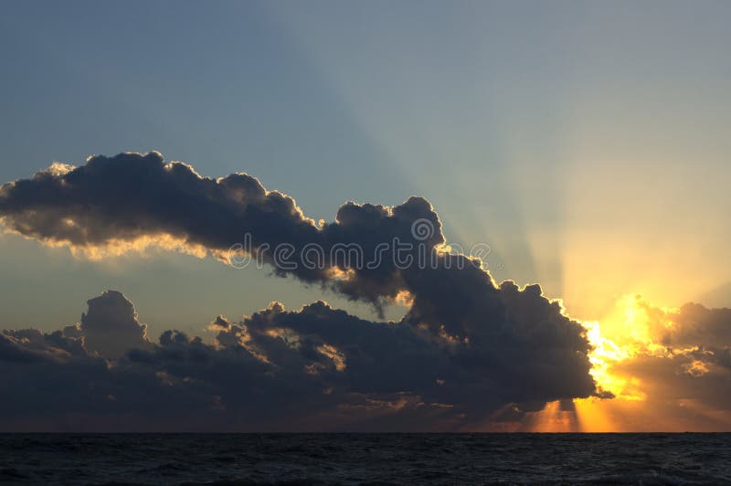 Sunset at the Sea. Sun Beams through the Clouds Stock Image - Image of ...