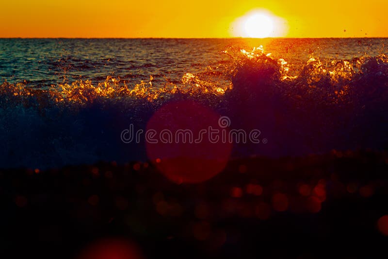 Sunset on Sea. Sun Sets Behind Horizon of Sea. Splash of Waves Stock ...