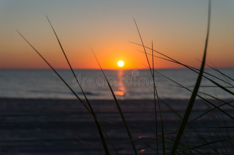 Sunset on the Seashore. the Sun is Setting Behind the Sea Horizon Stock ...