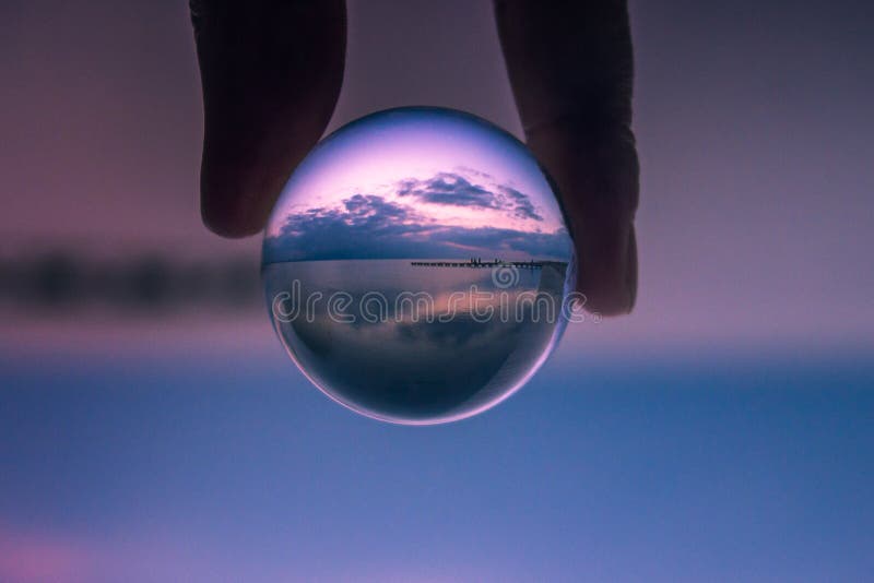 Sunset Seen in a Crystal Ball. Jetty on a Quiet Beach Stock Image ...