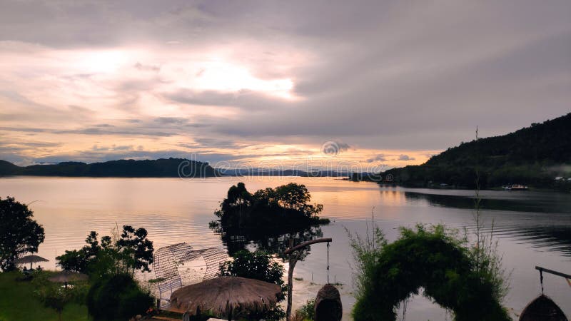 Sunset at sentani lake stock photo. Image of reflection - 202676850