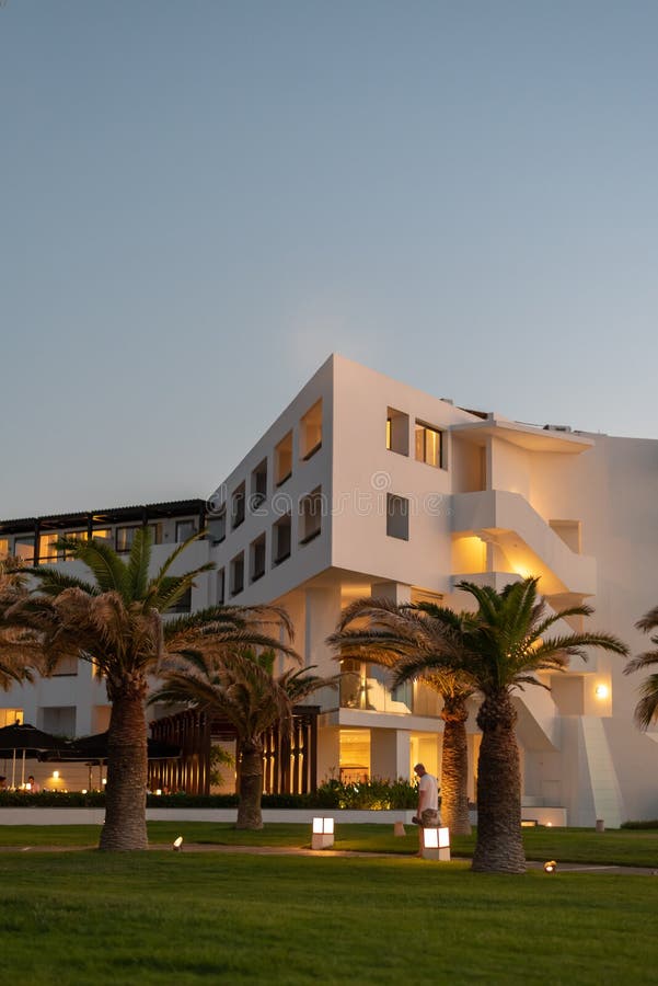 Sunset Shot of a Hotel Front. Palm Trees on the Lawn Stock Image ...