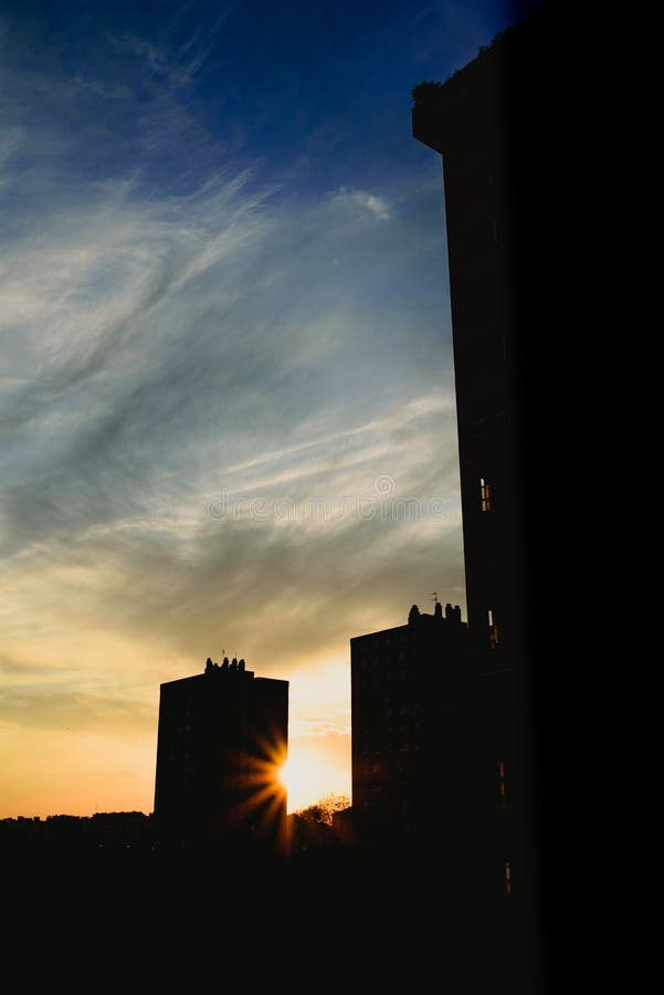 Sunset Silhouette in a City with the Warm Sun Behind Buildings Stock ...