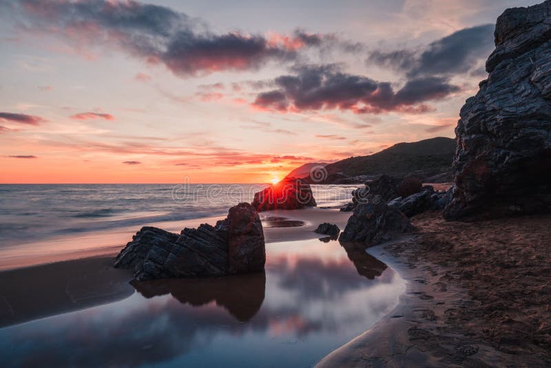 Sunset Sky Captured from the Beach with Rocks in the Water Stock Image ...
