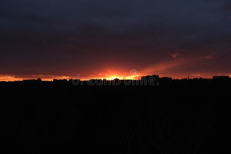 Sunset Sky with City in the Shadow Background and Red Tones of the ...