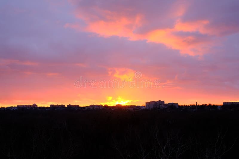 Sunset Sky with City in the Shadow Background and Red Tones of the ...