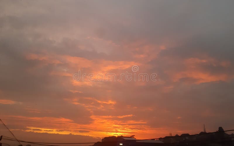 Sunset in the Sky with Cloudy Weather and Several Buildings at the ...