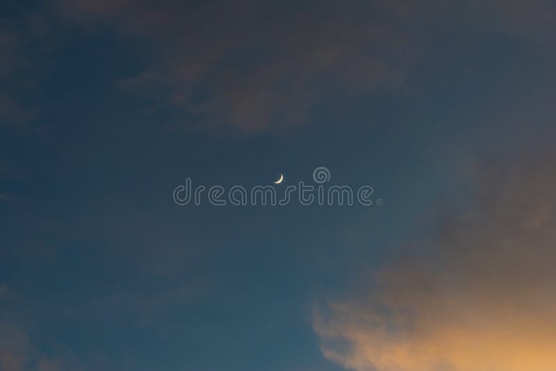 Sunset Sky with Golden Colored Clouds and Bright Moon in the Blue Sky ...