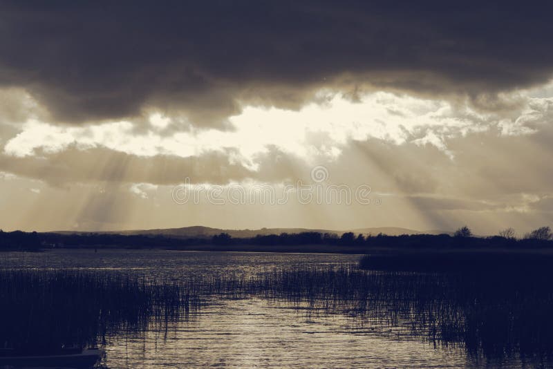 Sunset Sky Over a Lake.Dark and Dramatic Scene, Sun Rays Burst from the ...