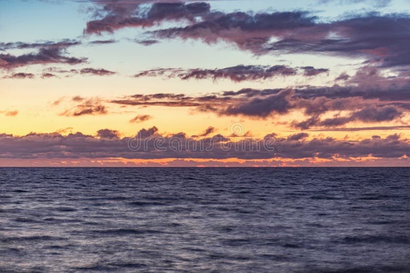 Sunset sky over the sea stock photo. Image of surface - 200003272