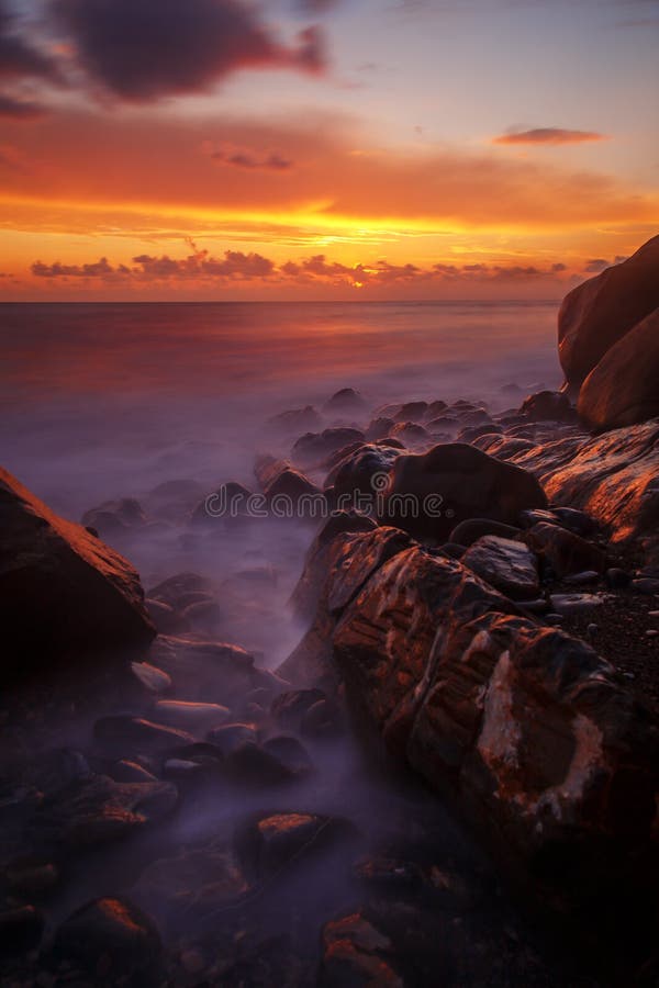 Sunset on the stone coast stock image. Image of seashore - 127996993