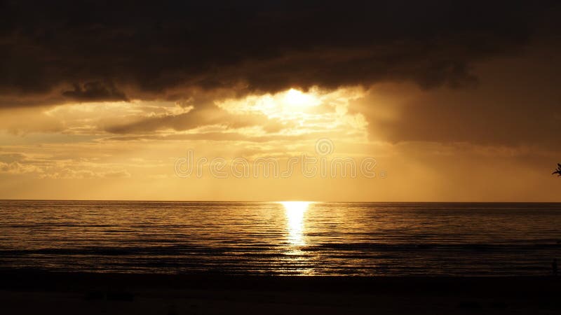 Sunset and storm clouds stock image. Image of orange - 55922643