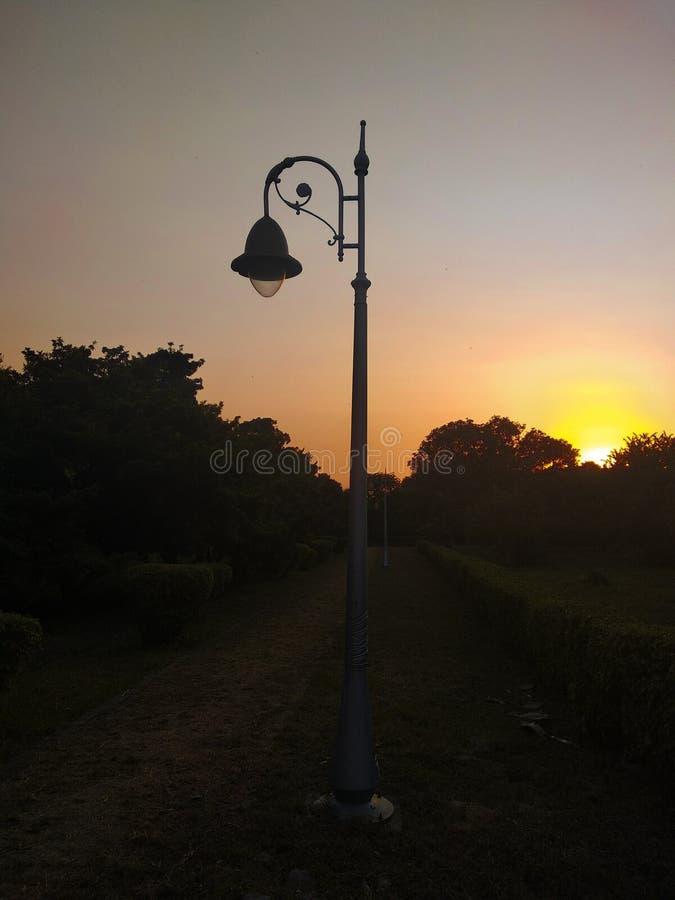 Sunset and street light stock image. Image of wind, evening - 184622353