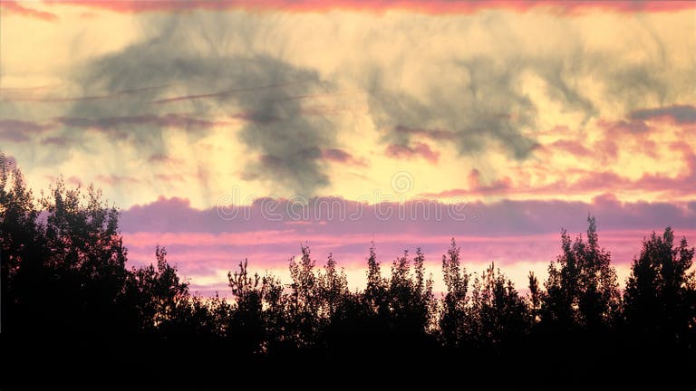 Sunset with a String of Sun-tinted Clouds Over the Forest Stock Photo ...