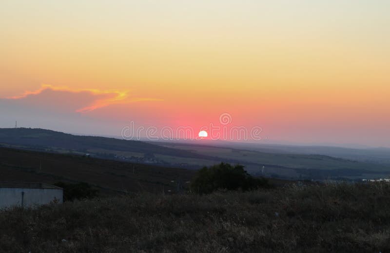 Sun goes behind the hills stock photo. Image of nature - 157222986