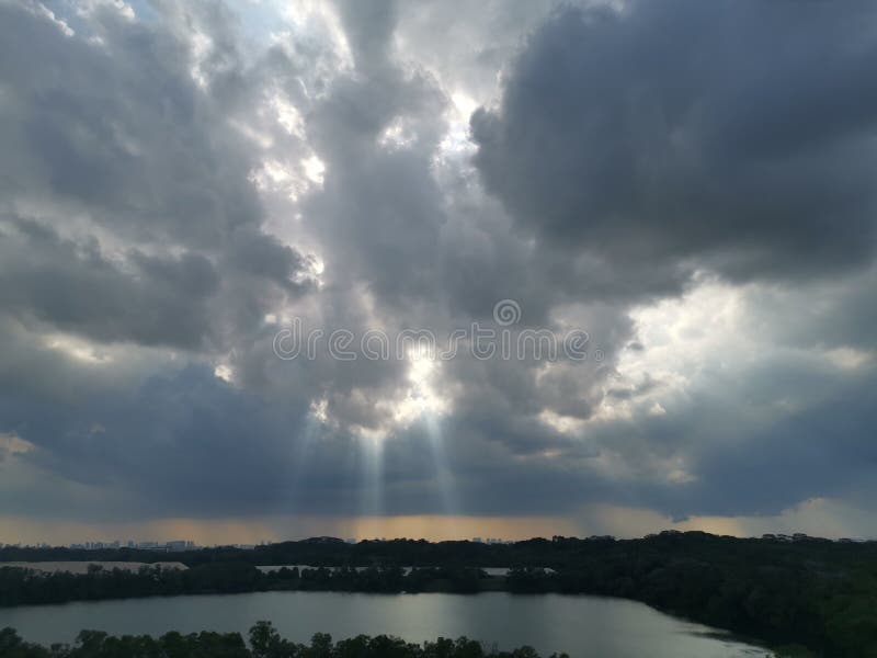 Sunset with Sun Ray Passing through Cloudy Sky Stock Image - Image of ...