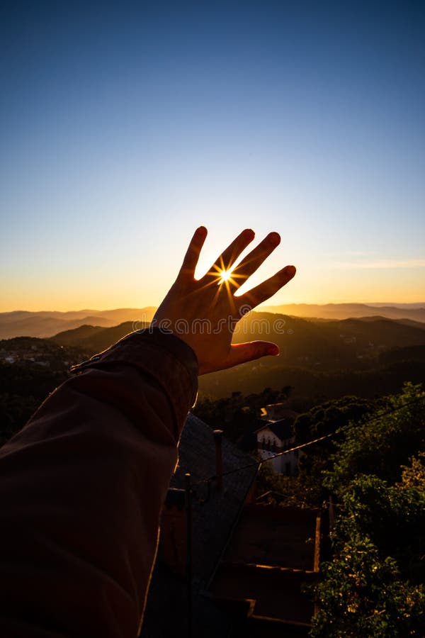 Sunset Sun Rays View through the Fingers of a Feminine Open Hand Stock ...