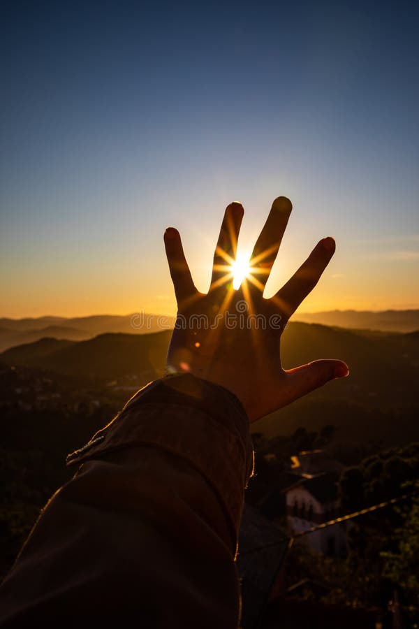Sunset Sun Rays View through the Fingers of a Feminine Open Hand Stock ...