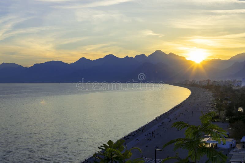 The Sunset Sun Sets Behind the Mountains Stock Photo - Image of ...