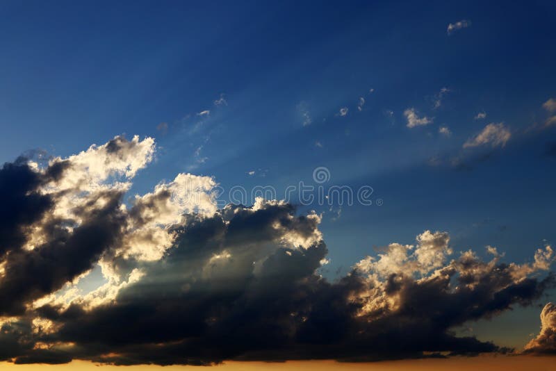 At Sunset the Sun Shines through Dark and Bright Clouds Stock Image ...