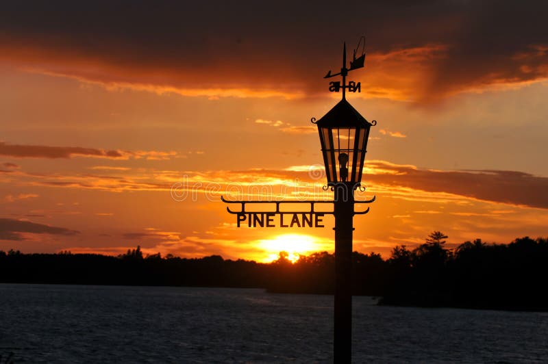 Sunset thru Lamp Post stock photo. Image of evening, sign - 15769462