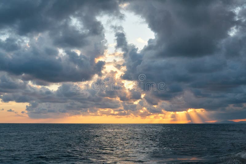 Sunset in the Tropical Sea. Sun Beam through Clouds Stock Image - Image ...