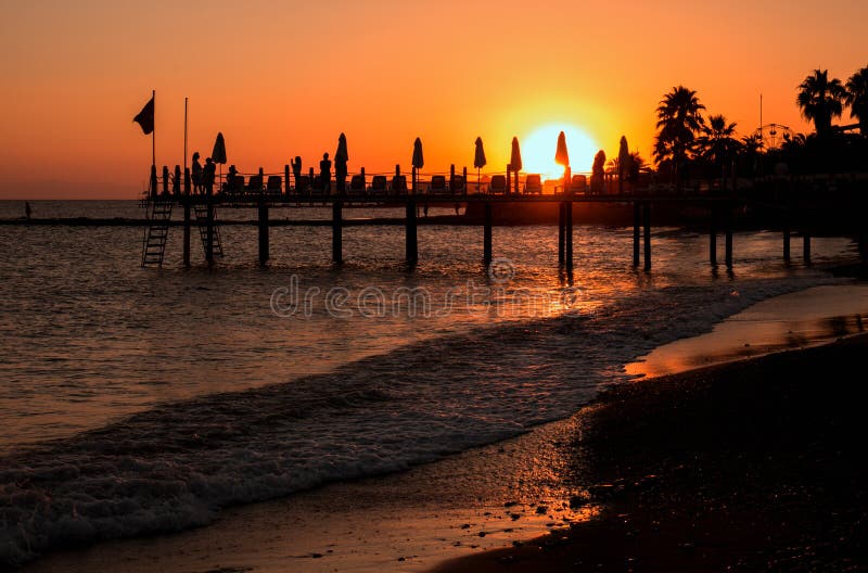 Sunset on a Turkish beach stock photo. Image of building - 96695188