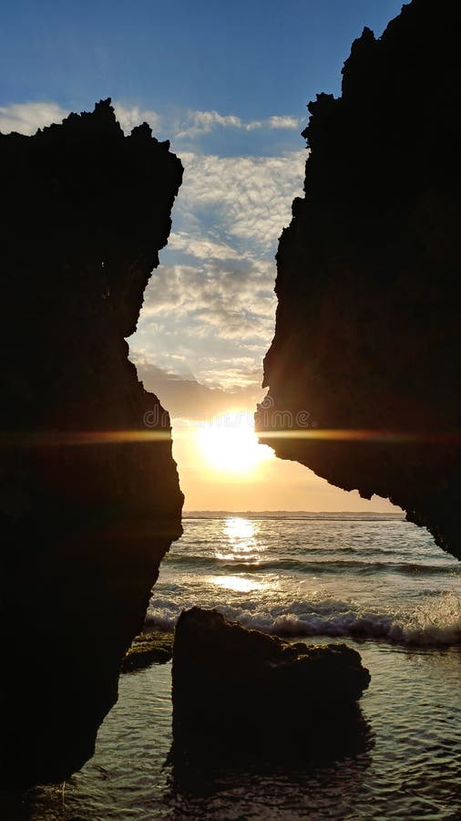 Sunset between Two Cliffs Silhouette at the Beach Stock Photo - Image ...